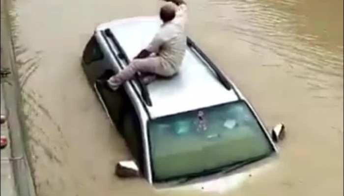 car and man stuck in flood video viral flood video social media