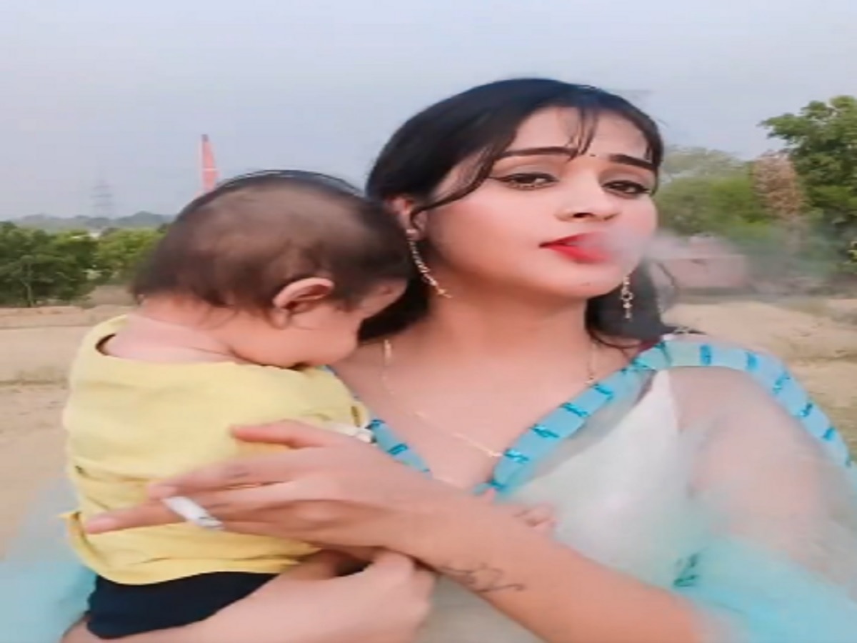 viral video women making reel cigarette smoke blown on small child face ...